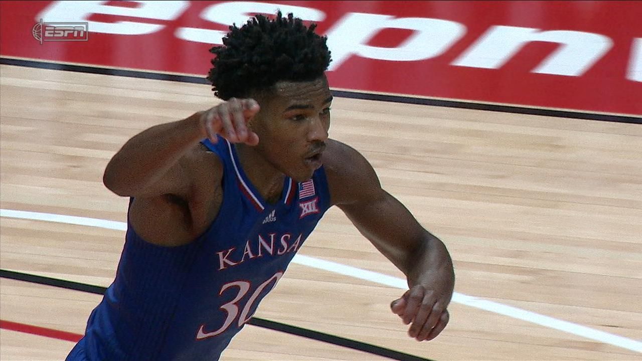 Ochai Agbaji rocks the rim with a powerful flush over his defender ...